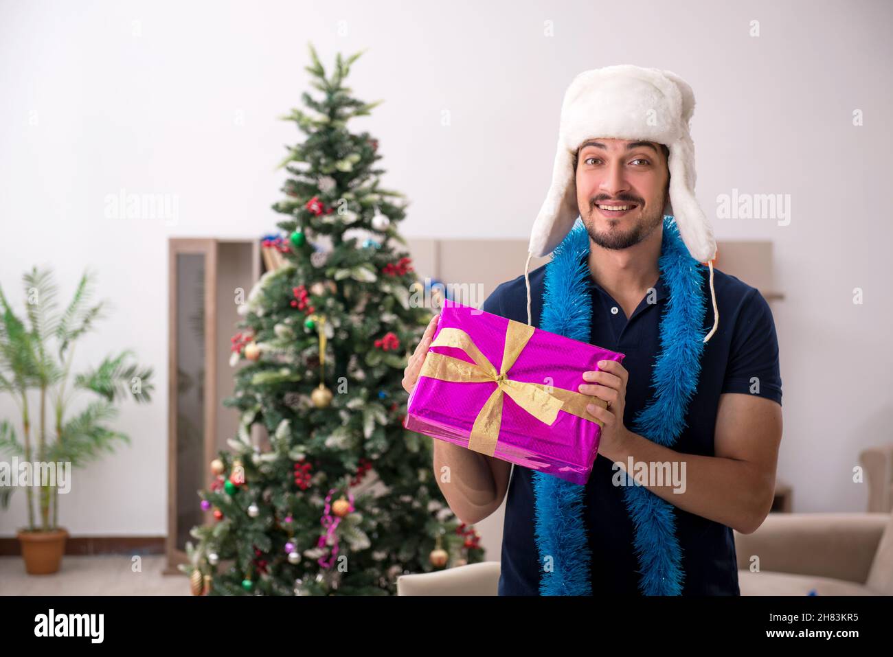 Young man celebrating New year at home alone Stock Photo - Alamy