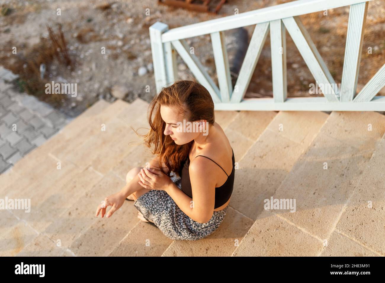 Sad girl sitting on stairs hi-res stock photography and images - Alamy