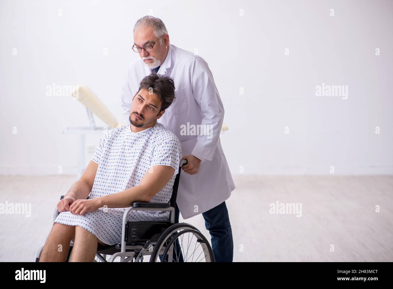 Old doctor psychiatrist examining young disabled patient Stock Photo ...