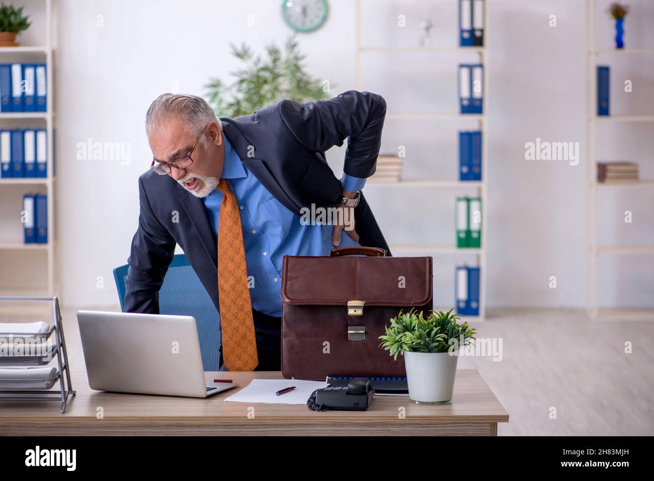 Old male employer working in the office Stock Photo - Alamy