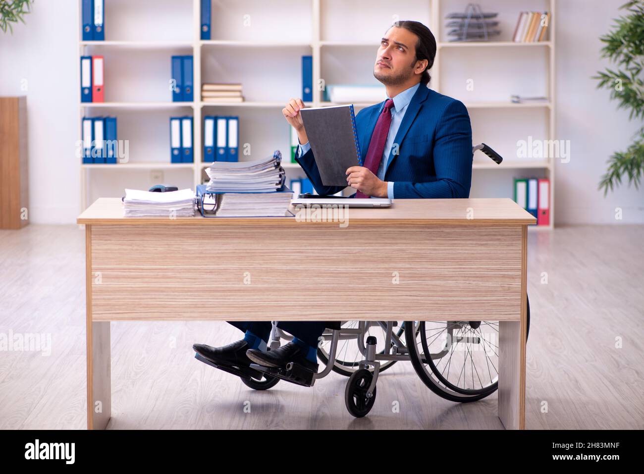 Young male disabled employee working in the office Stock Photo - Alamy