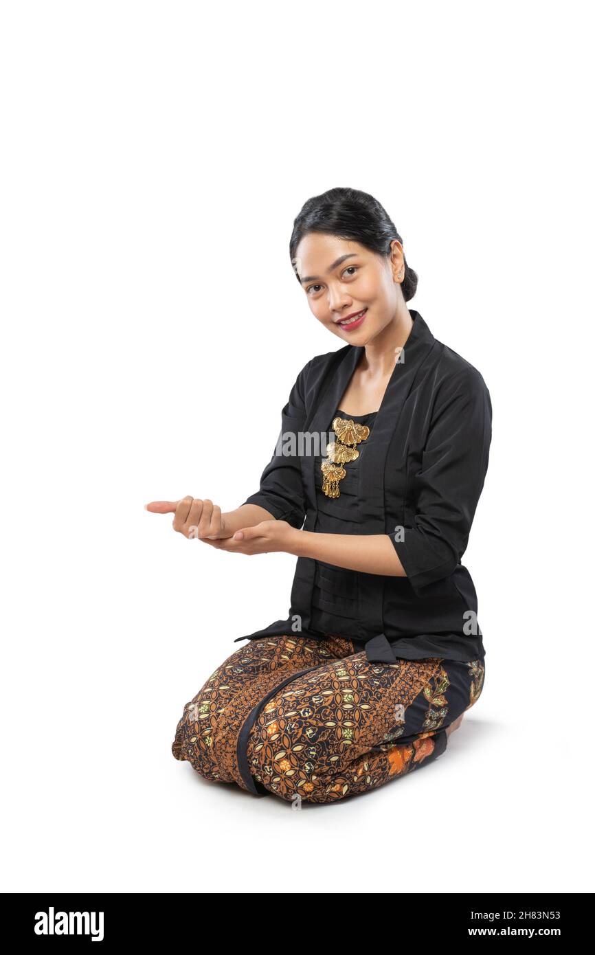 beautiful woman wearing traditional Javanese clothes presenting ...