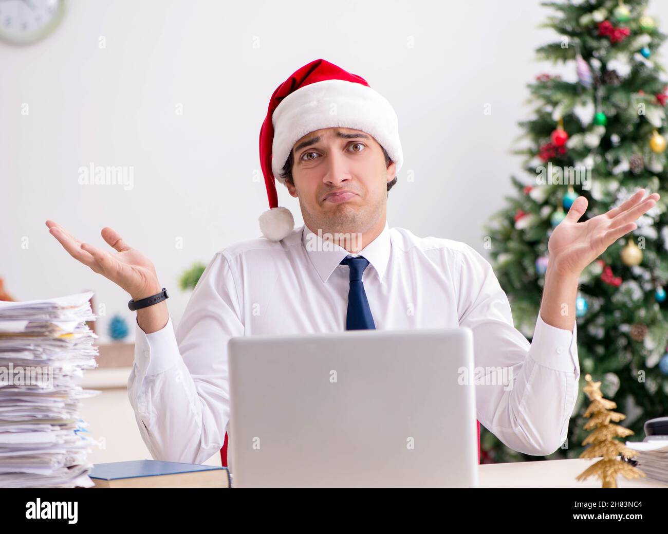 The young worker working in office on christmas shift Stock Photo - Alamy