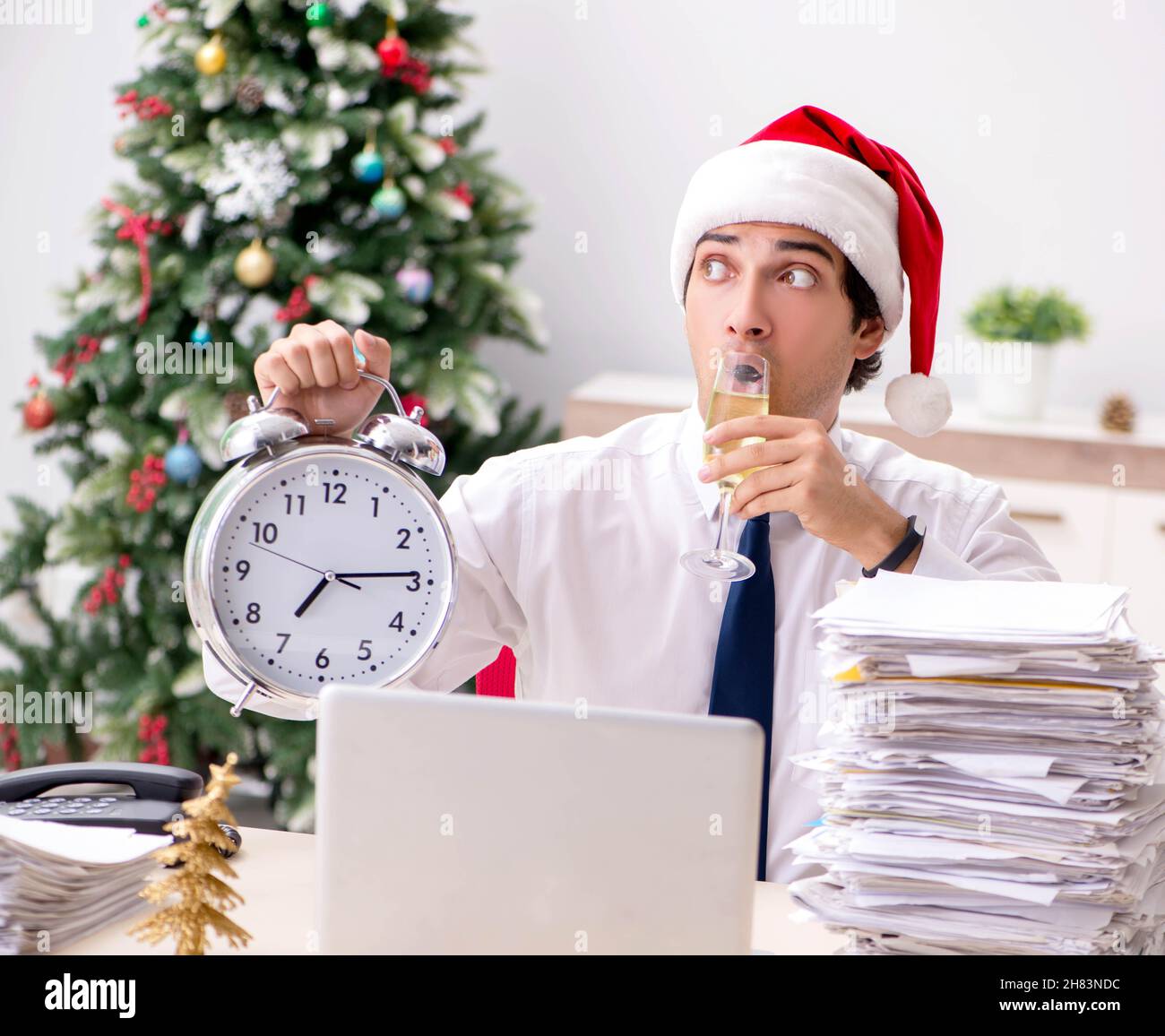 The young worker working in office on christmas shift Stock Photo - Alamy