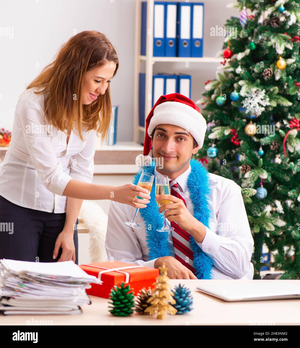 The colleagues celebrating christmas in office Stock Photo - Alamy