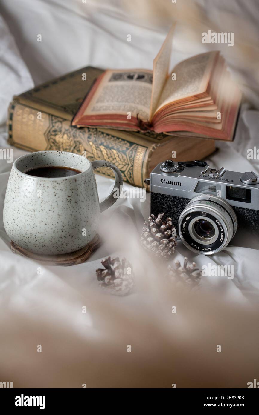 Coffee in bed with books and camera Stock Photo - Alamy