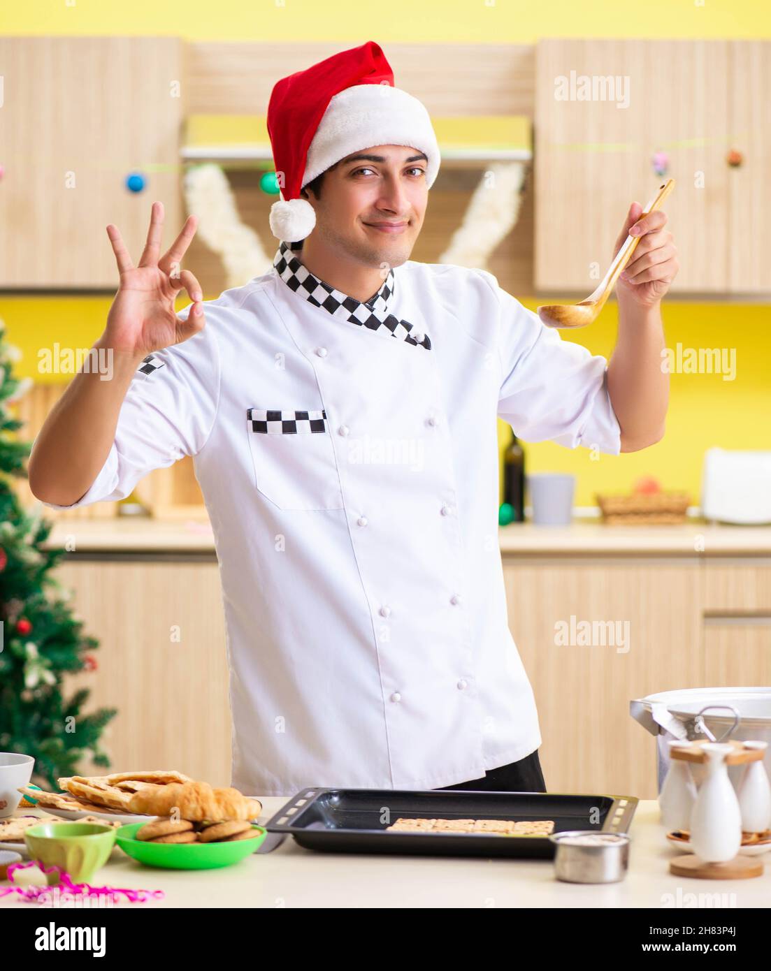 The young chef husband working in kitchen at christmas eve Stock Photo ...