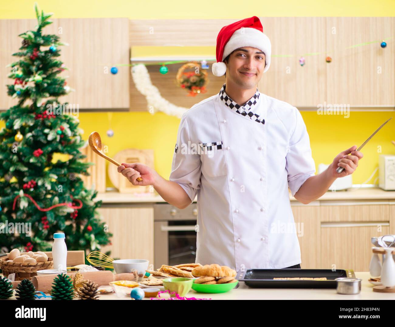 The young chef husband working in kitchen at christmas eve Stock Photo ...