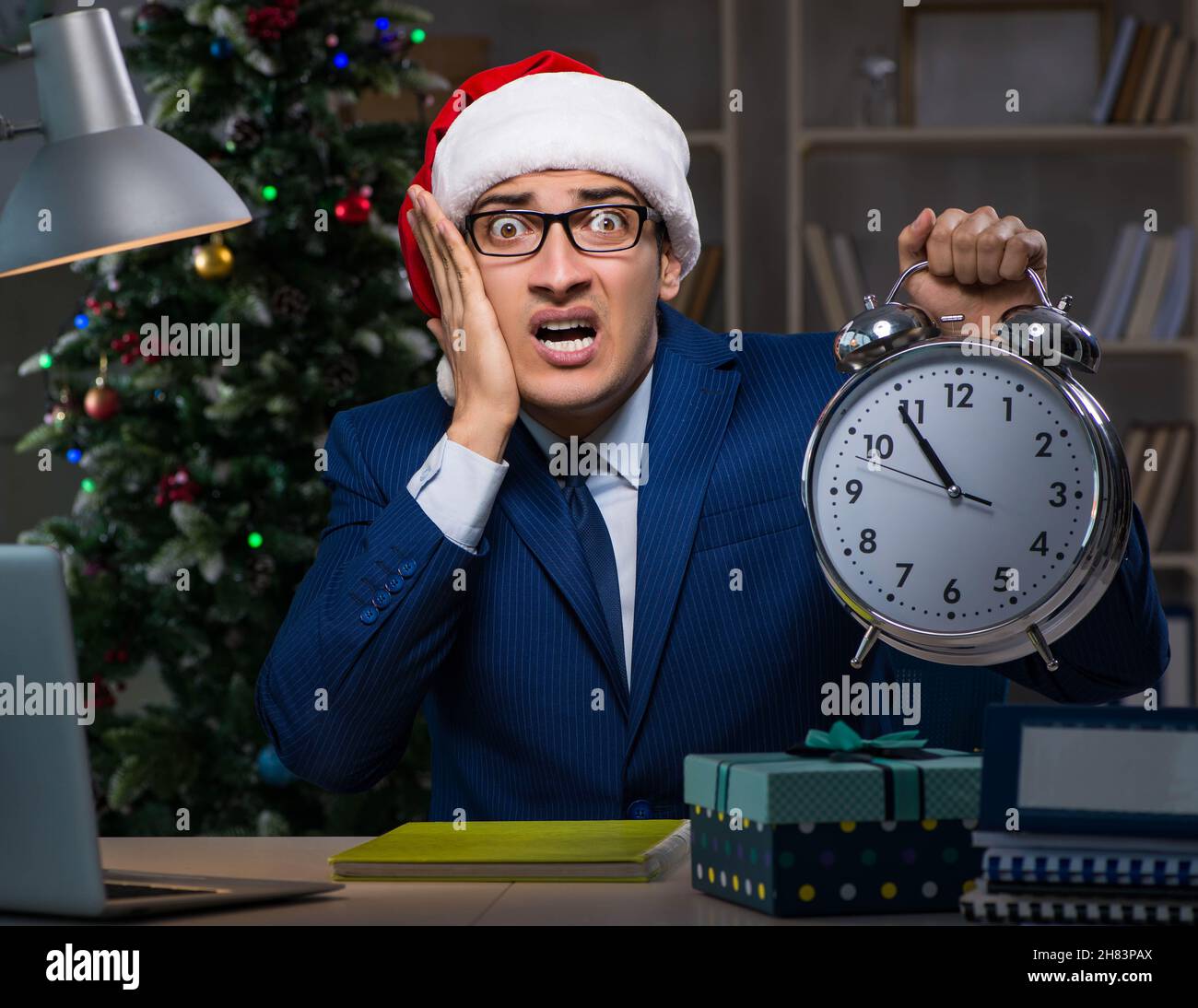 The businessman working late on christmas day in office Stock Photo - Alamy