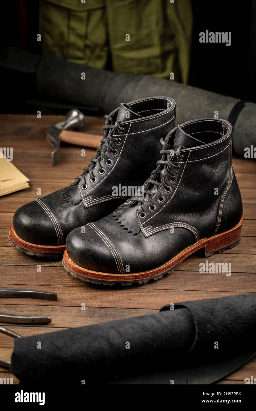Hand crafted black leather high boots Stock Photo - Alamy
