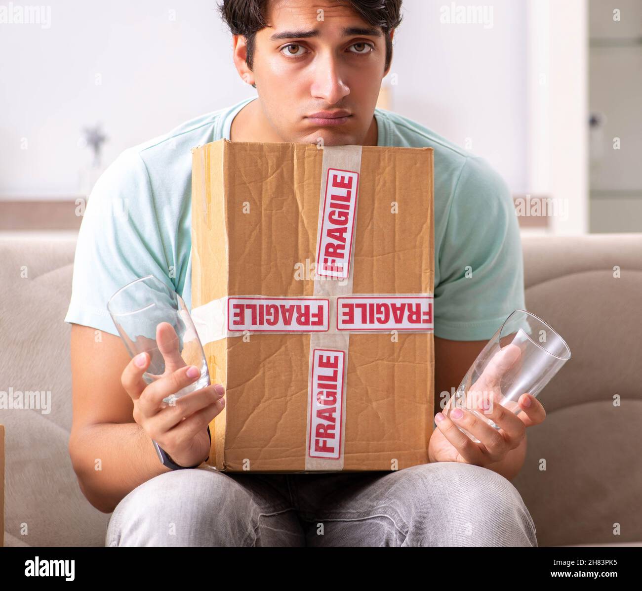 The man opening fragile parcel ordered from internet Stock Photo - Alamy