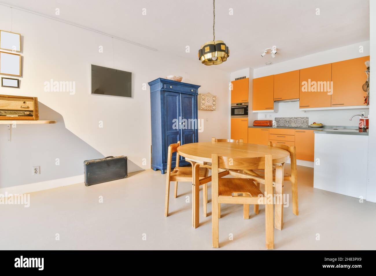 Stylish kitchen design with orange kitchen set Stock Photo - Alamy