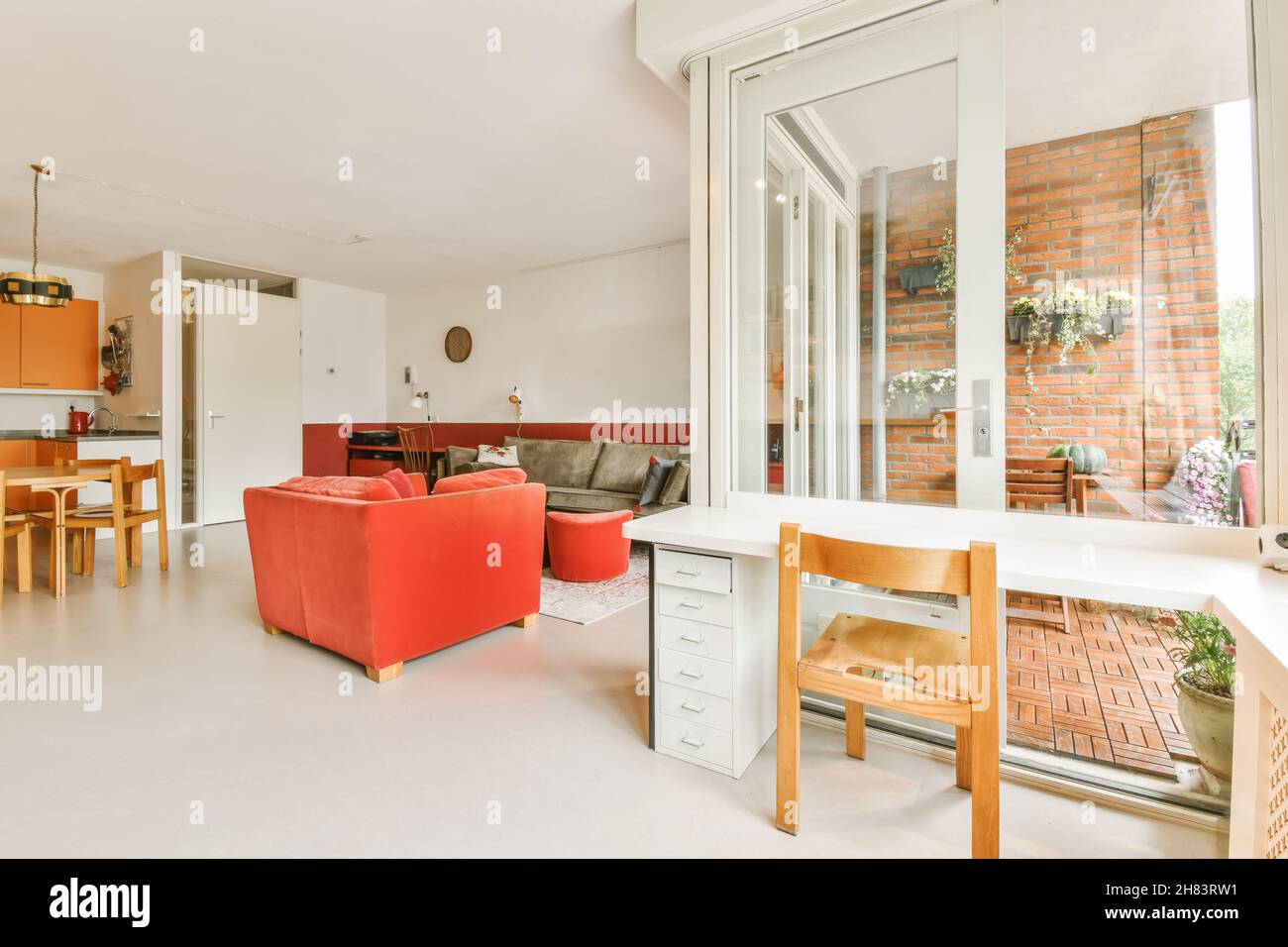 A room with large windows and a table adjacent to the window Stock ...
