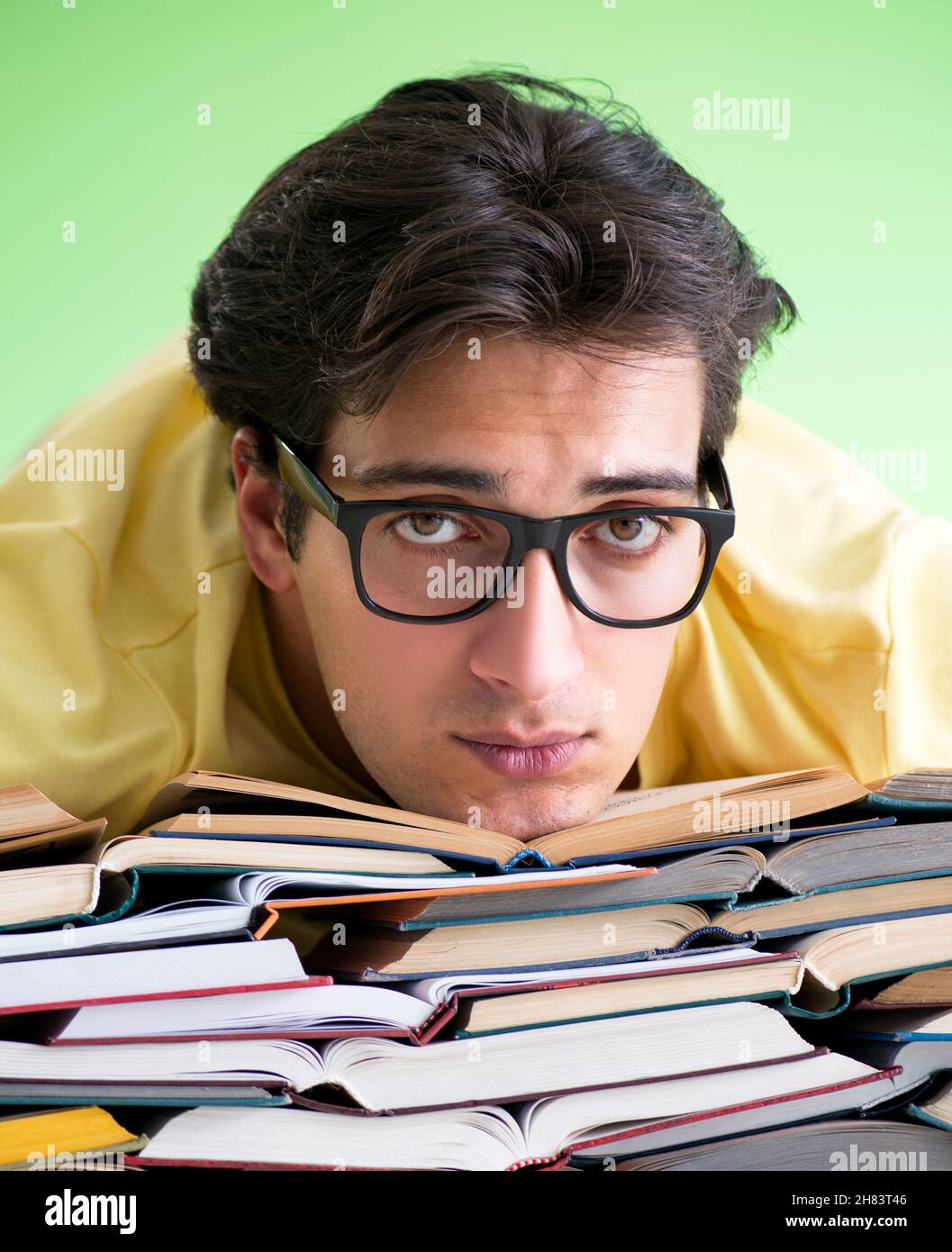 The student with too many books to read before exam Stock Photo - Alamy