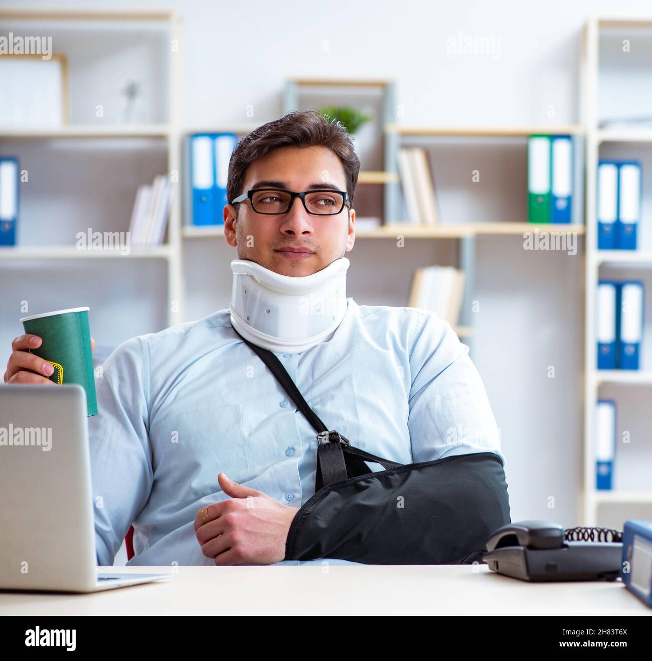 The businessman with broken arm working in office Stock Photo - Alamy