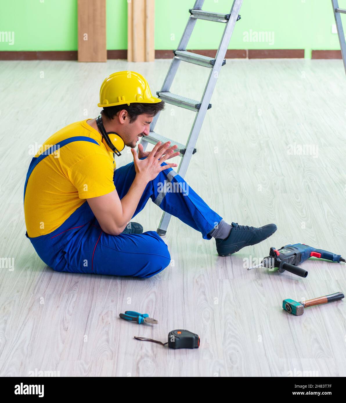 The injured worker at the work site Stock Photo - Alamy