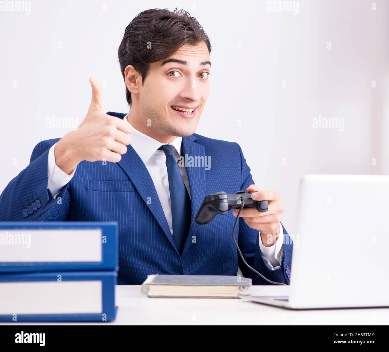 The young handsome businessman playing computer games at work office ...