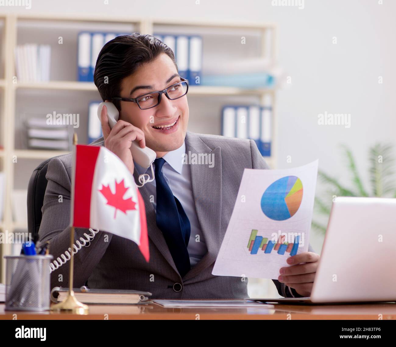 The businessman with canadian flag in office Stock Photo - Alamy