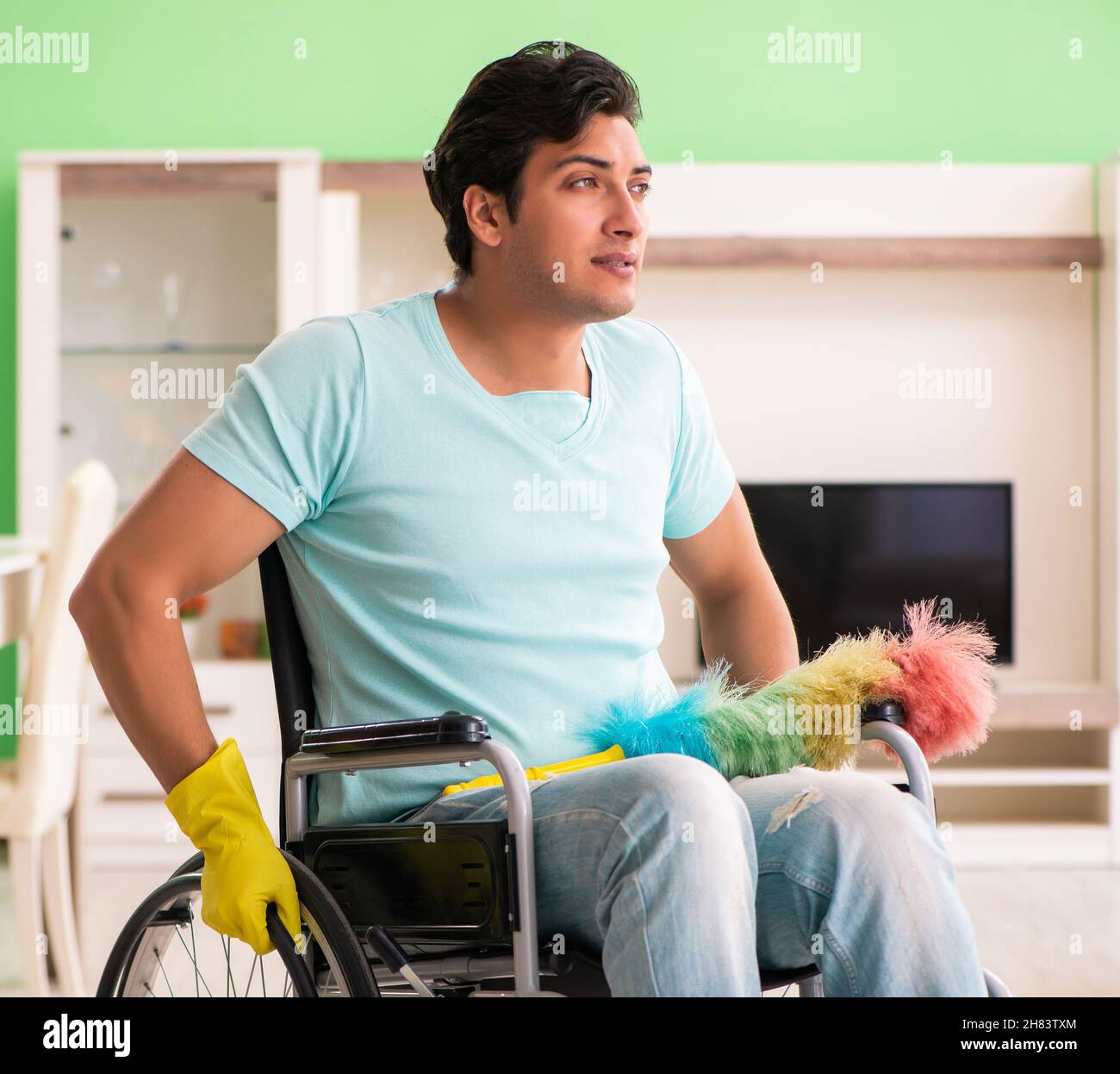 The disabled man on wheelchair cleaning house Stock Photo - Alamy