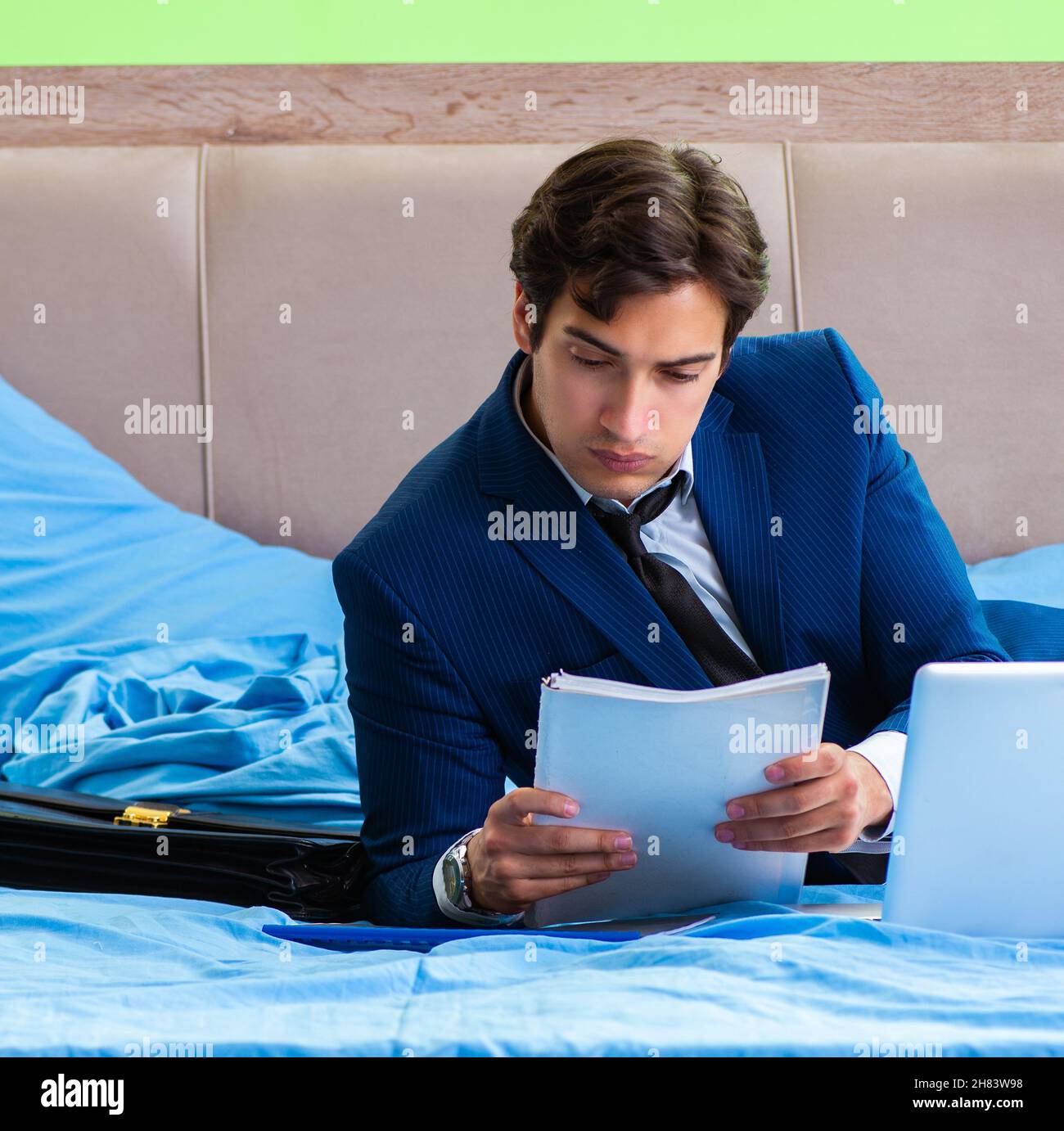 The businessman working in the hotel room Stock Photo - Alamy