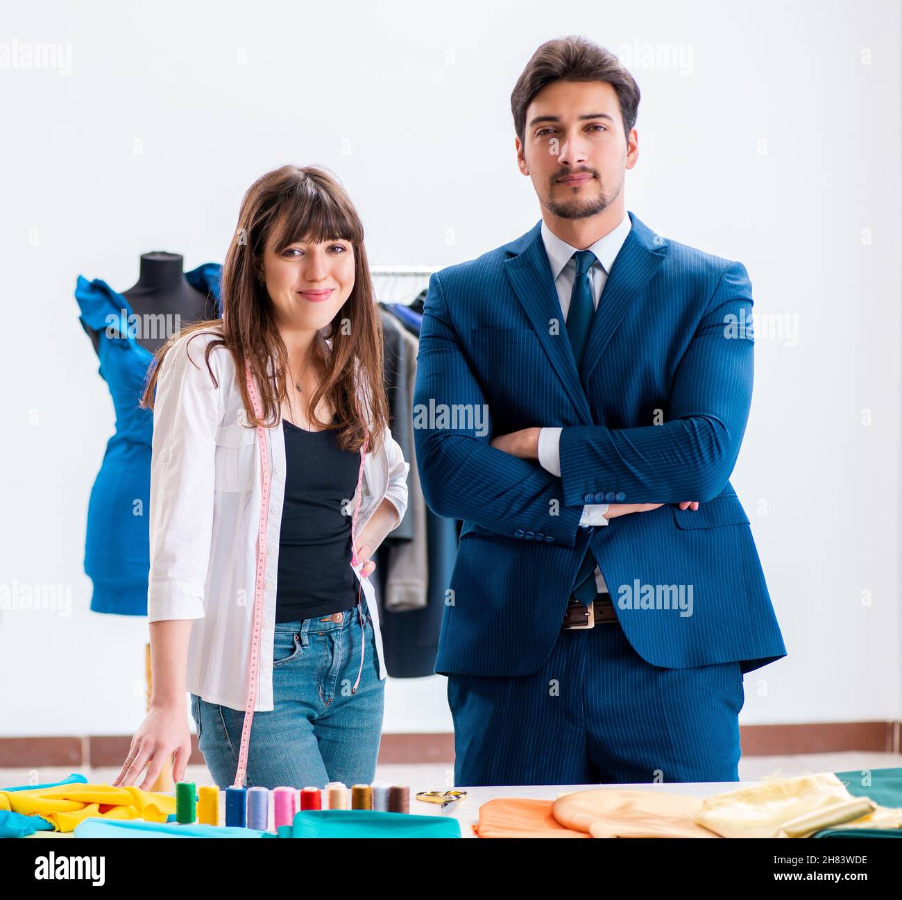 The professional tailor taking measurements for formal suit Stock Photo - Alamy