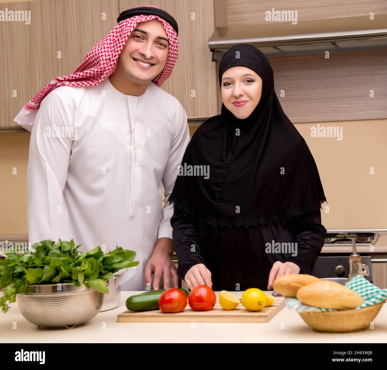The young arab family in the kitchen Stock Photo - Alamy