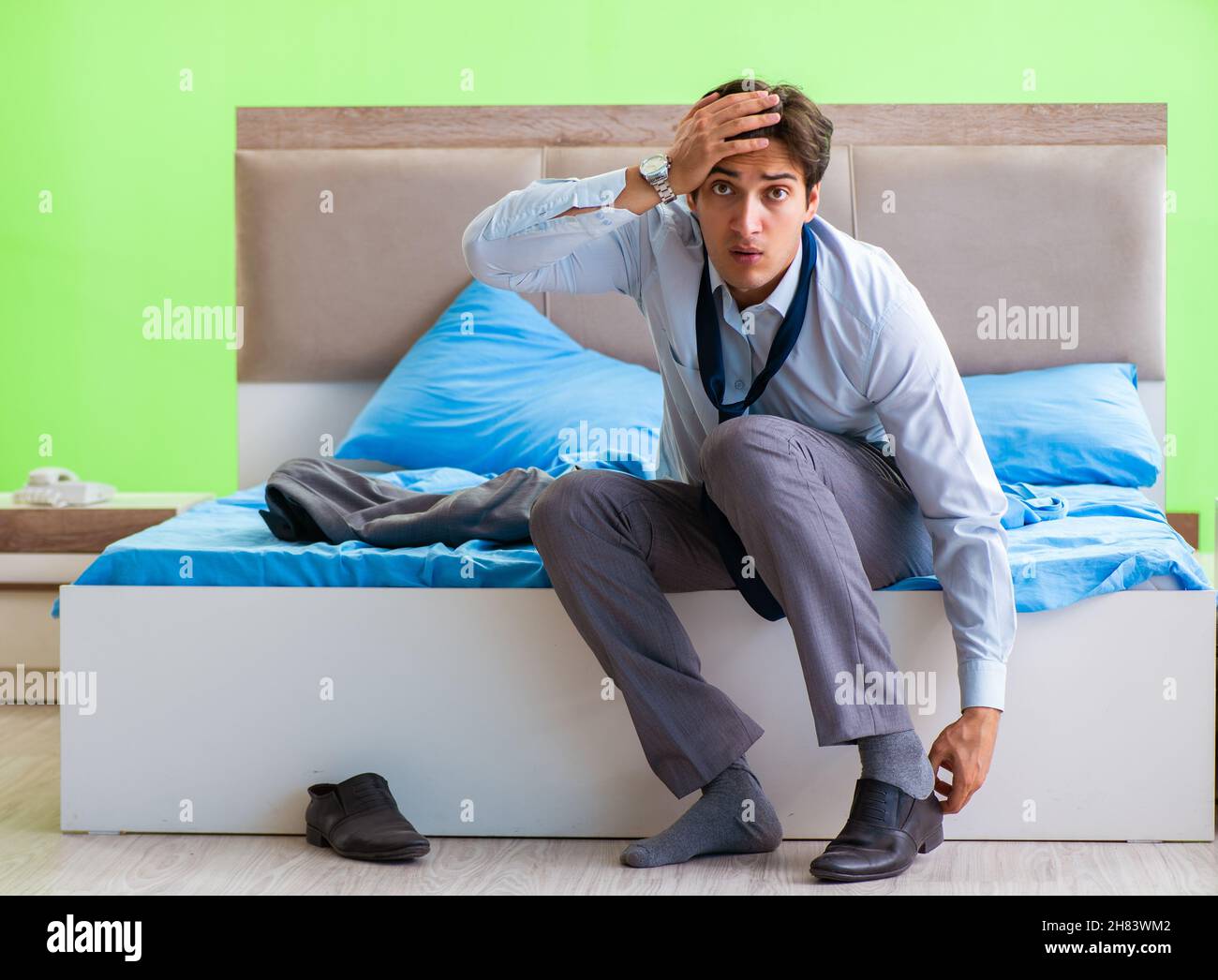 Employee in the bedroom being late for job Stock Photo - Alamy
