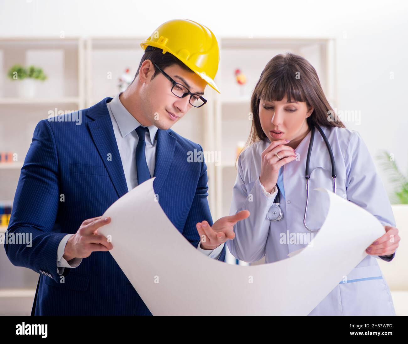 The doctor discussing new hospital plan with architect Stock Photo - Alamy