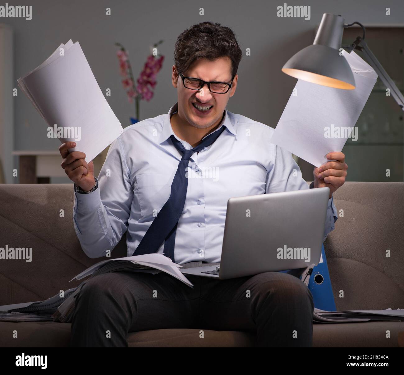 The businessman workaholic working late at home Stock Photo - Alamy