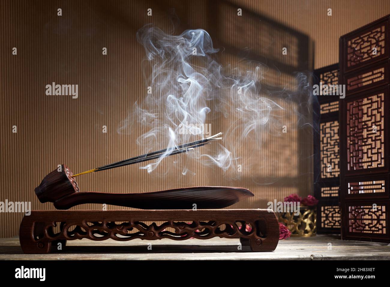 Smoke from burning incense sticks standing on lotus incense holder ...