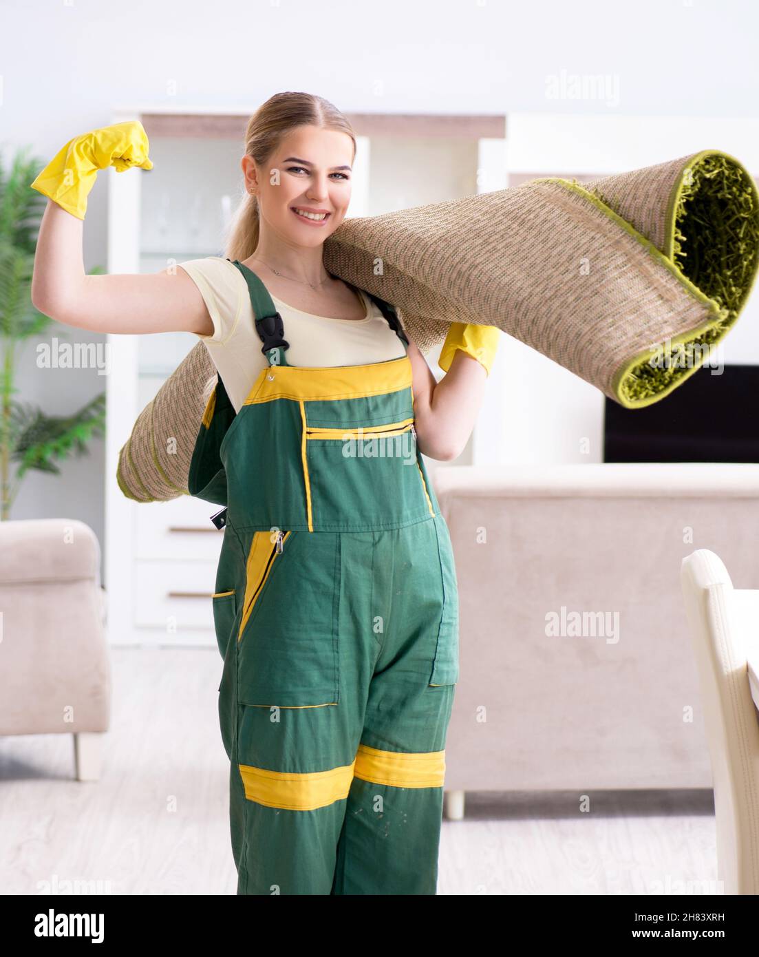 The professional female cleaner cleaning carpet Stock Photo - Alamy