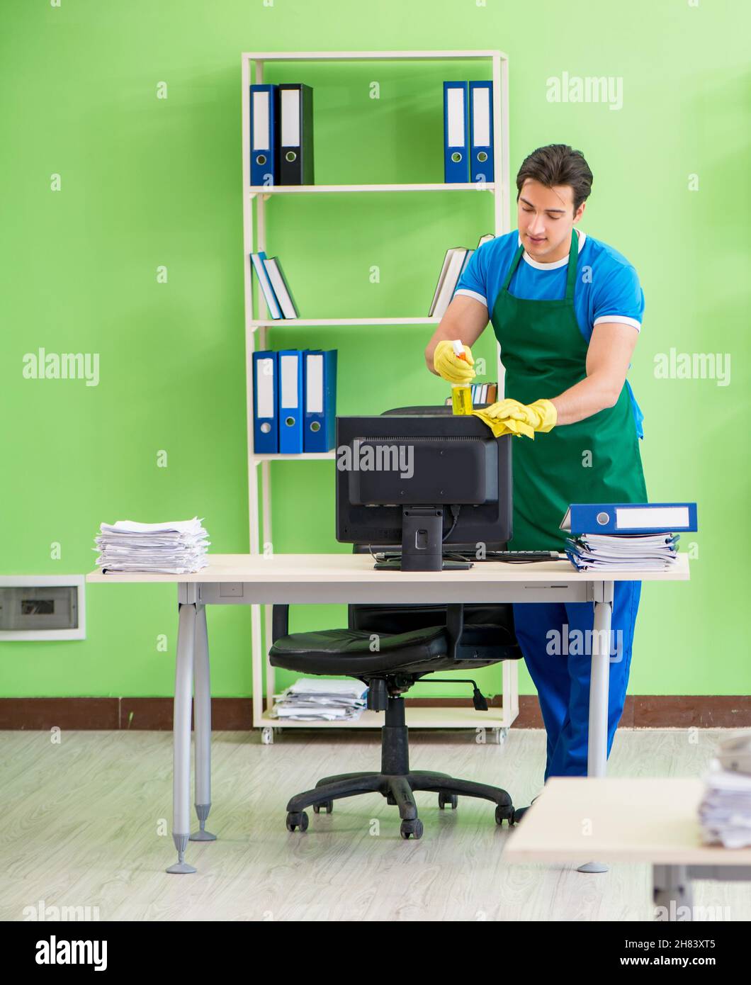 The male handsome professional cleaner working in the office Stock ...