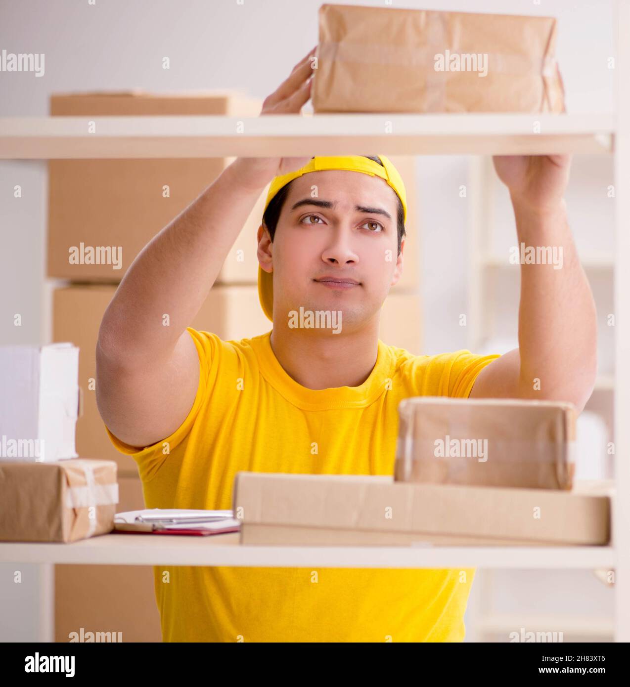 The man working in postal parcel delivery service office Stock Photo ...