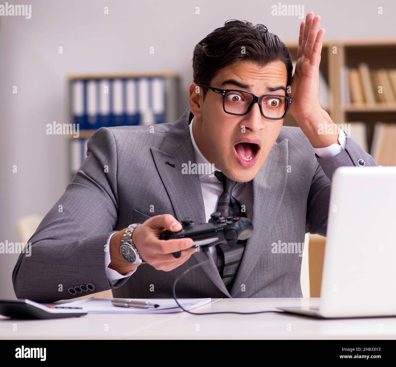 The businessman playing computer games at work office Stock Photo - Alamy