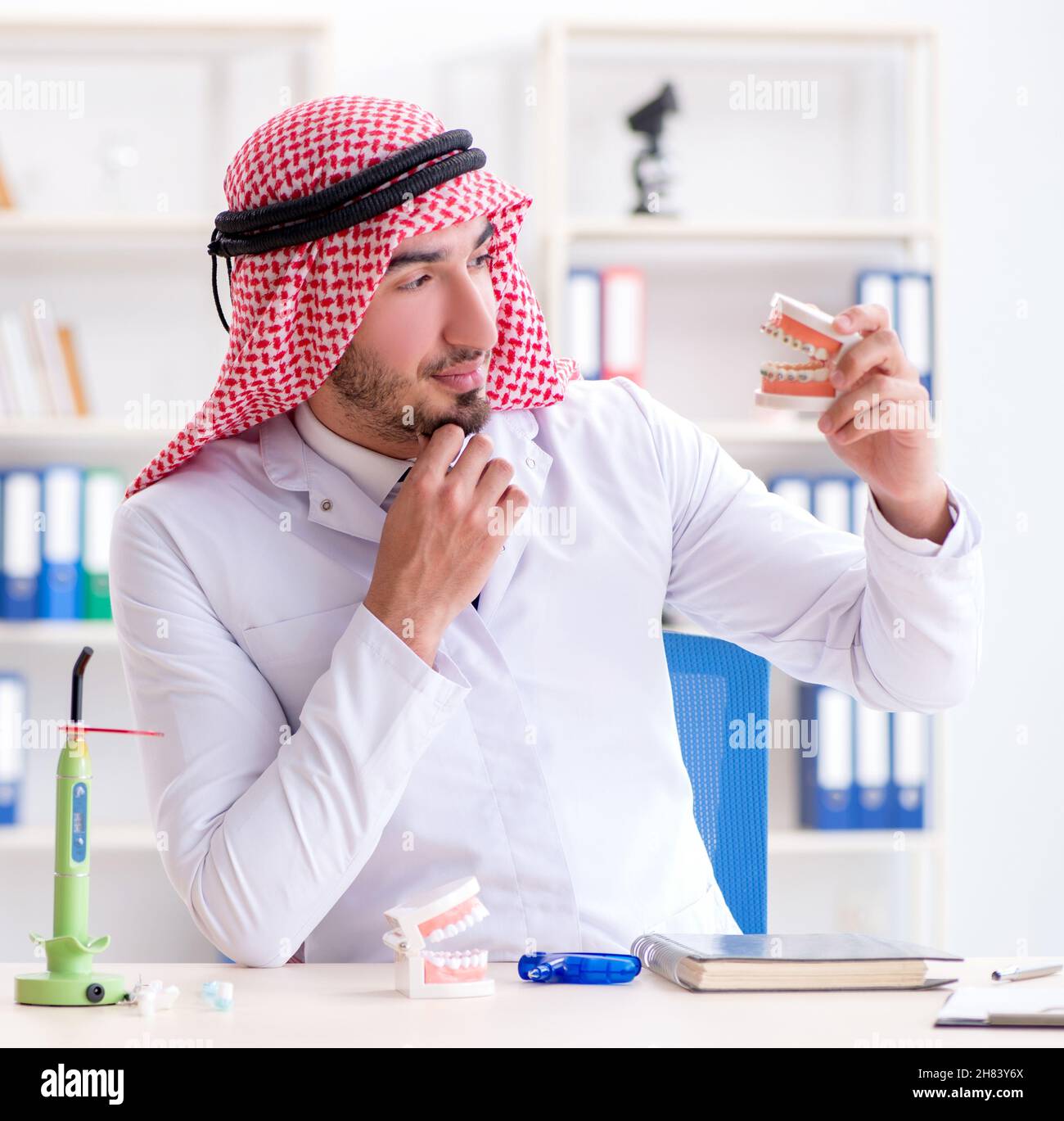 The arab dentist working on new teeth implant Stock Photo - Alamy