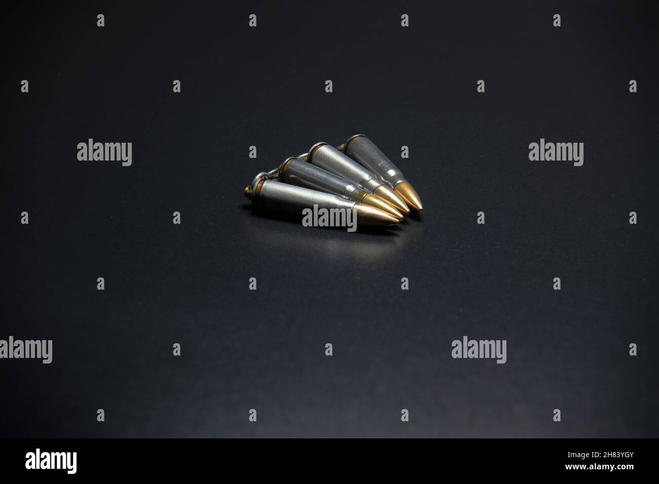 Bullet isolated on black background with reflexion. Rifle bullets close ...