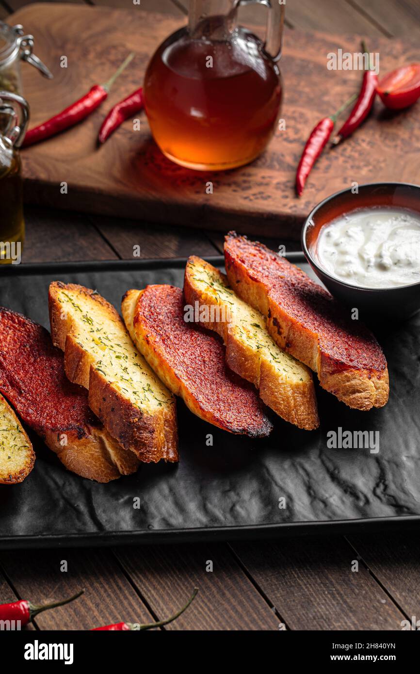 Fried garlic bread appetizer with sauce Stock Photo - Alamy