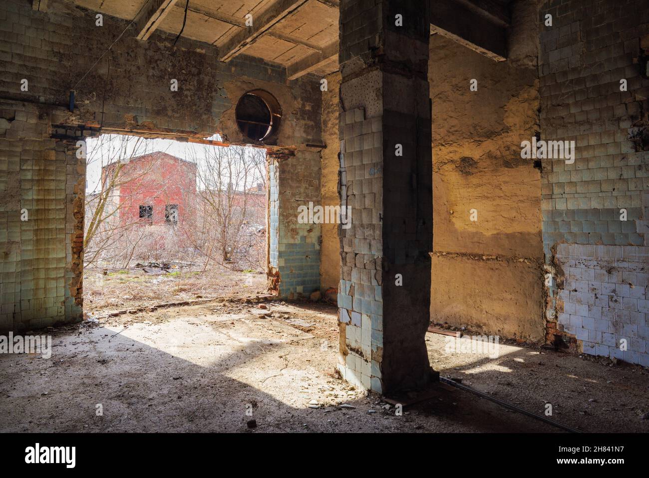 Abandoned Soviet construction with brick columns at sunny day interior ...
