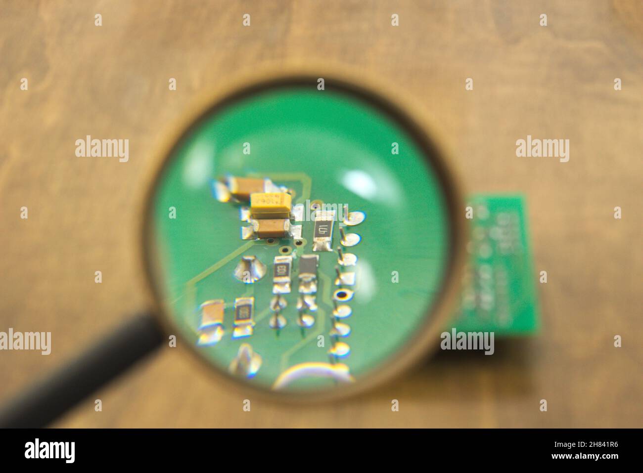 Printed circuit board under a magnifying glass Stock Photo - Alamy