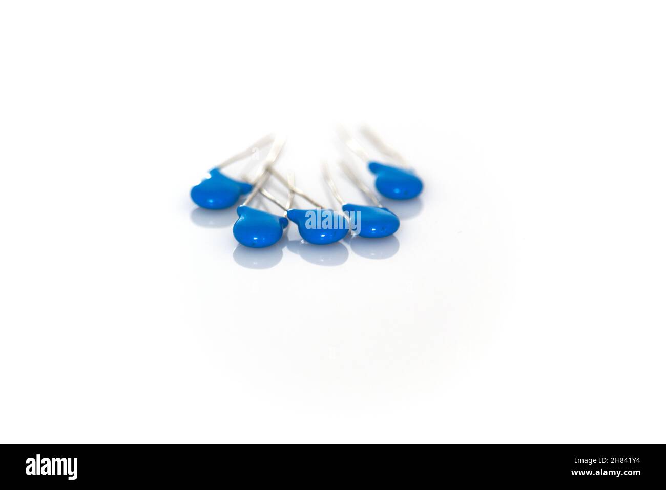 Ceramic capacitors on mirror background. Electronic components Stock ...