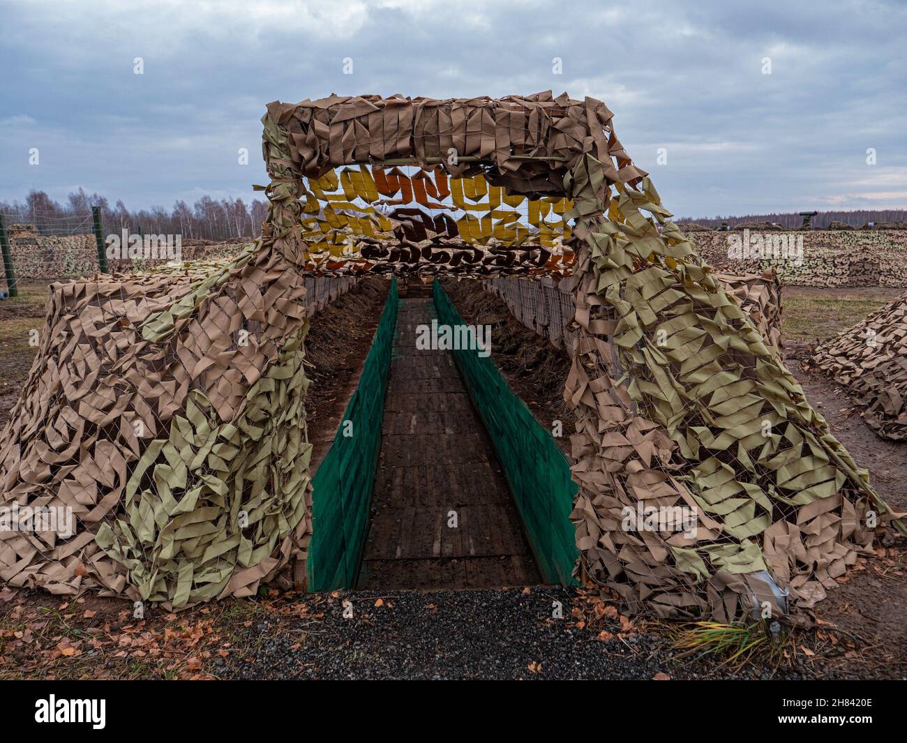 A trench on the front line, covered with camouflage netting Stock Photo ...