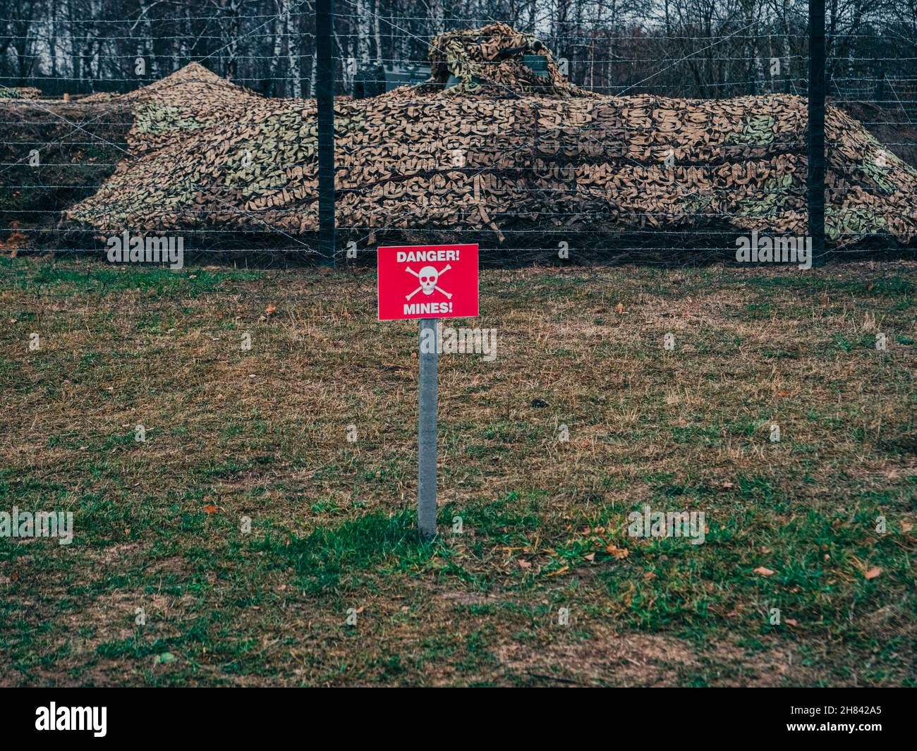 A sign warning of mines in front of the line of demarcation. Security ...