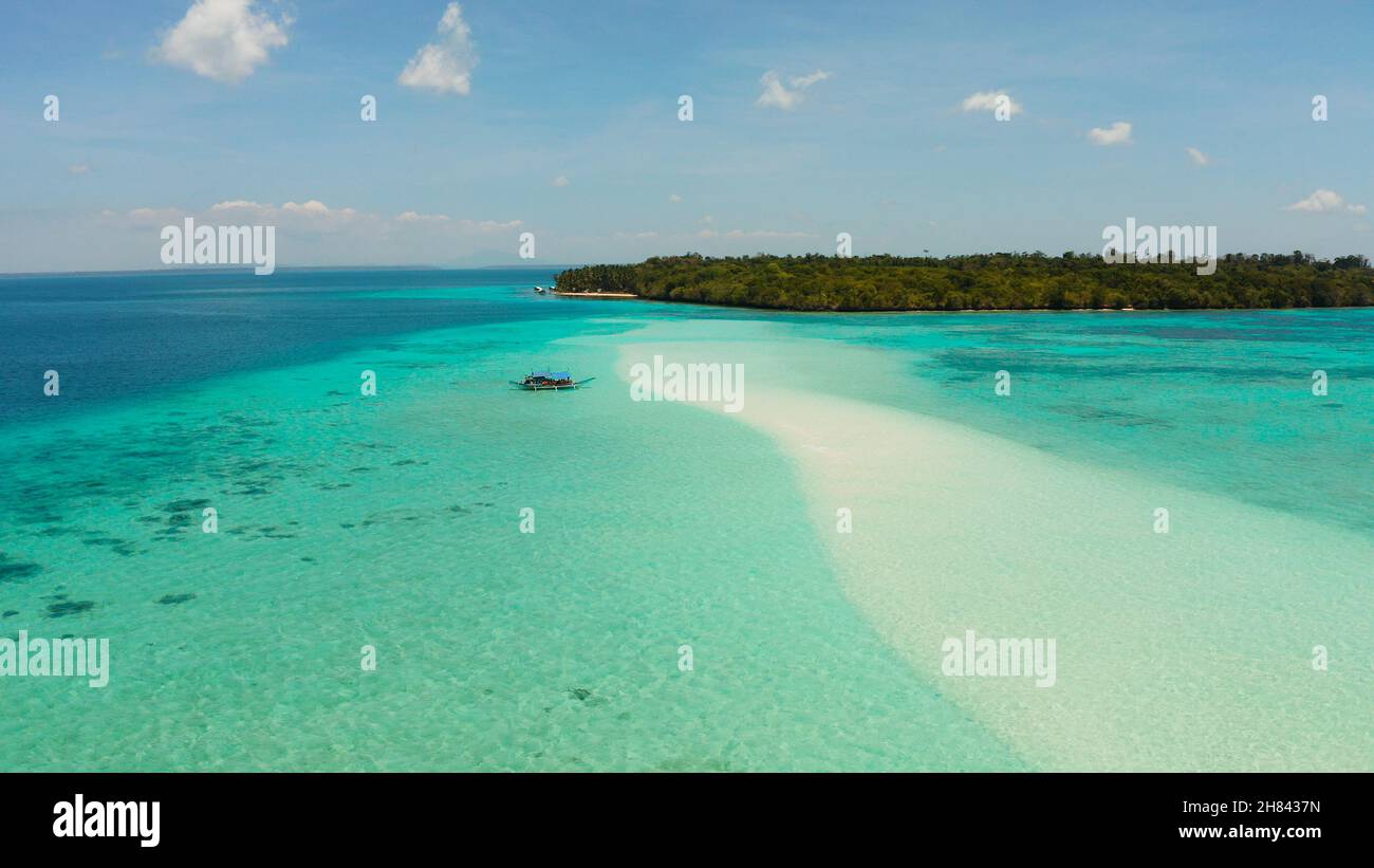 Seascape with a beautiful beach and tropical island surrounded by a ...
