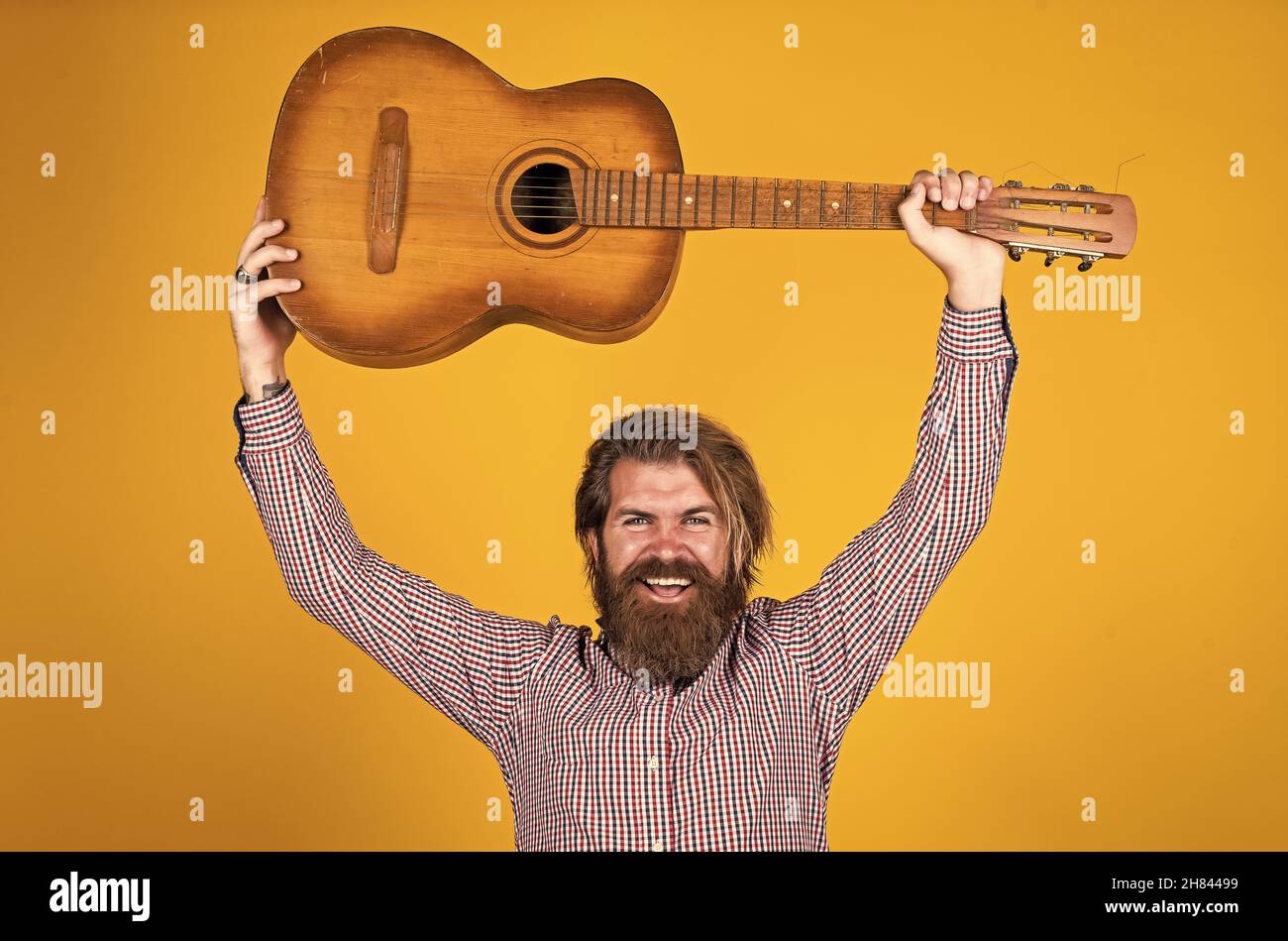 mature hipster musician with beard. brutal caucasian guy playing guitar ...