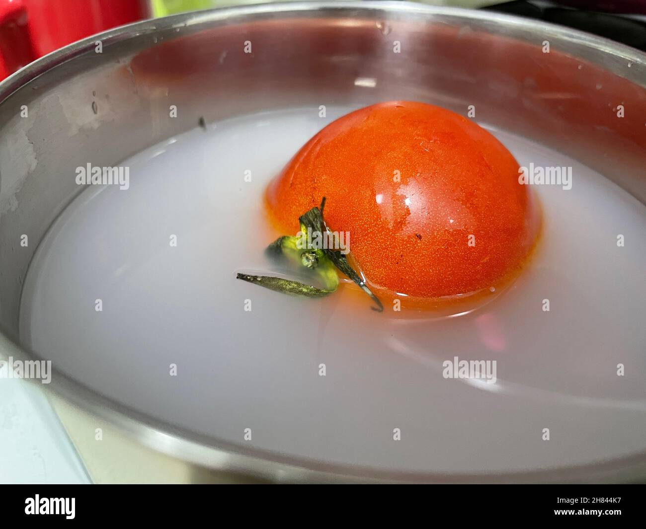 Washing tomato at home with rice water Stock Photo - Alamy