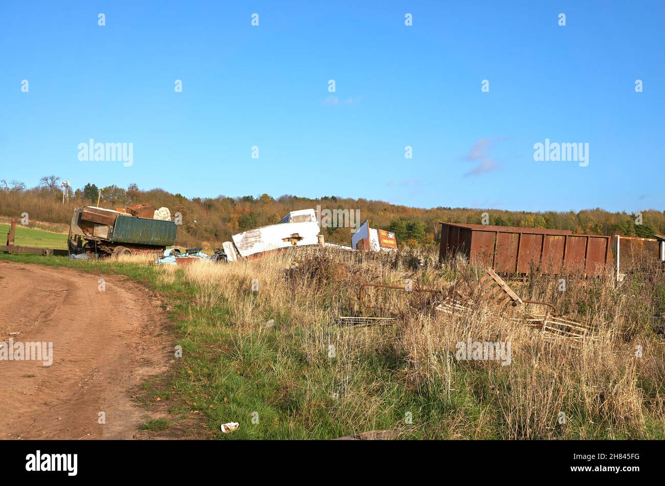 Old trailers and boats dumped in a field Stock Photo - Alamy