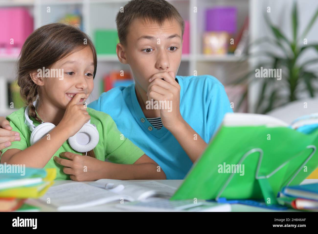 Portrait of brother and sister doing homework together Stock Photo - Alamy