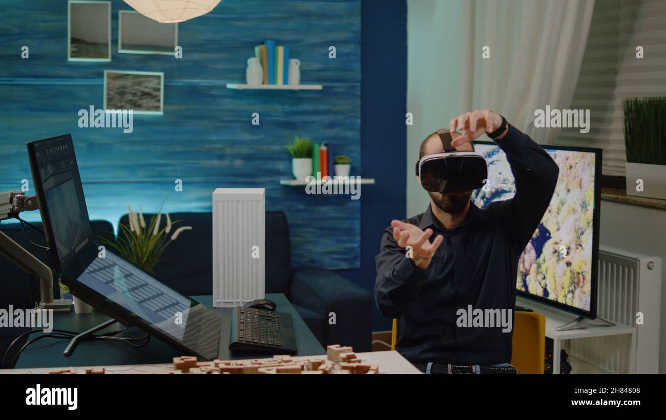 Man architect working with vr glasses on building plan development in ...