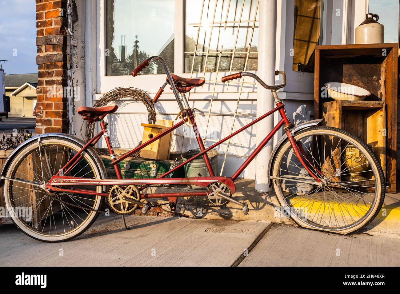An old antique bicycle built for two in front of a country store in ...