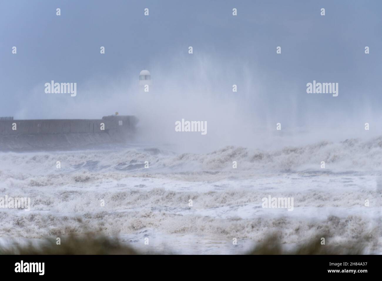 Huge waves crash over the South Gare lighthouse as Storm Arwen batters ...